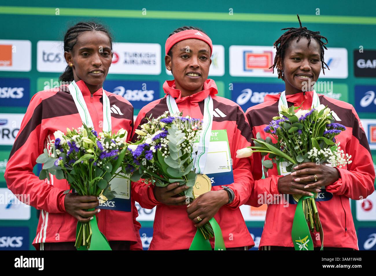 Golden medalist Bedatu Hirpa poses on the podium next to silver ...