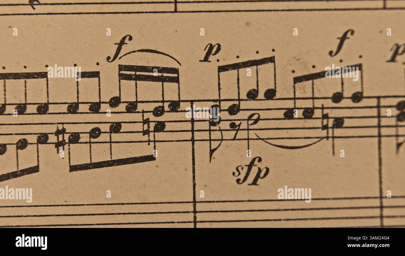 Macro of Mozart aged book with music notes sheet. Educational symbols ...