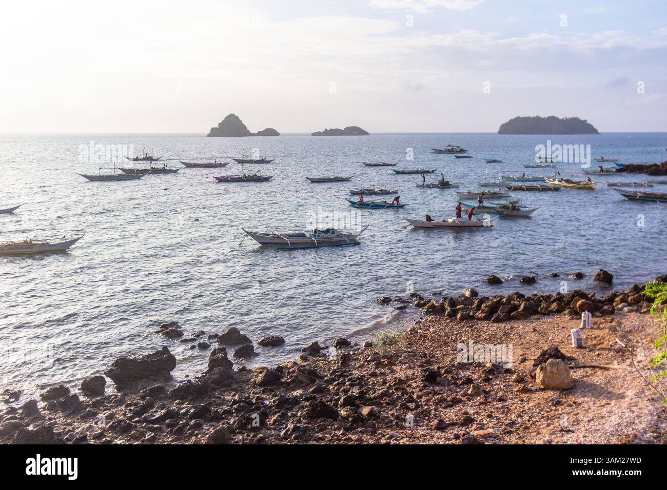 A fleet of fishing boats, or banca, docked in shallow waters off Isla ...