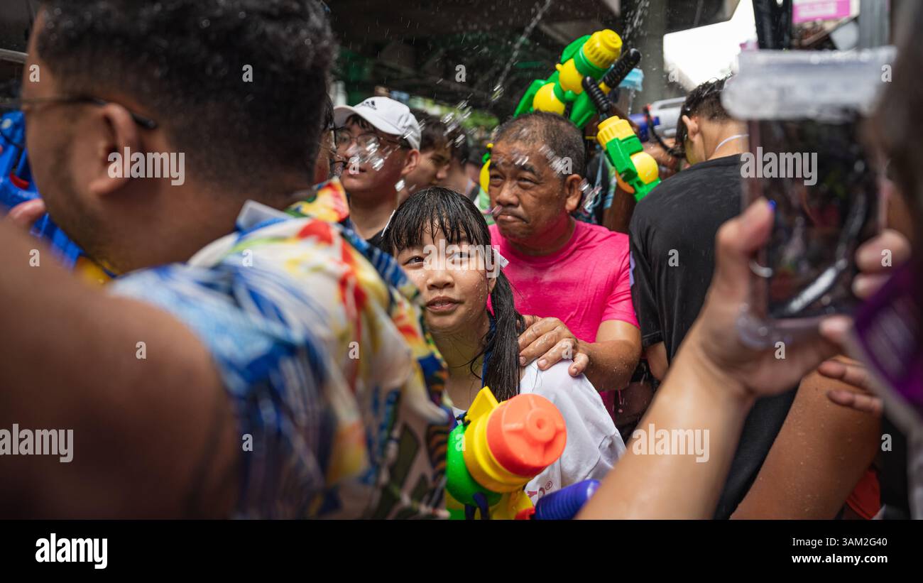 People make their way through the large crowd during Songkran ...