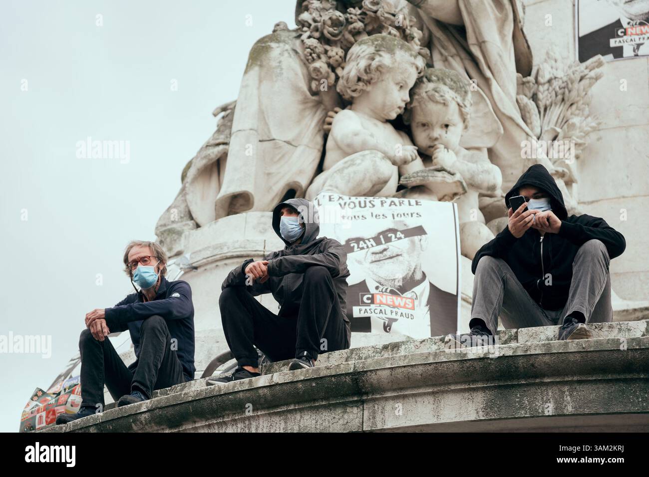 A group of protesters hangs posters depicting Vincent Bollore with the ...