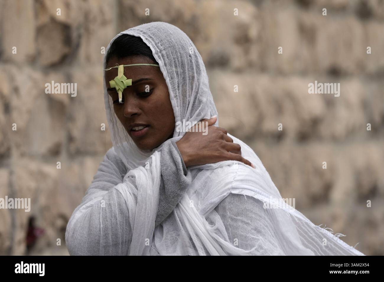 An Ethiopian Orthodox Christian walks on the eve of Palm Sunday holiday ...