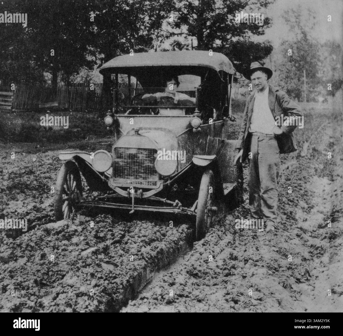 June 1, 1900 - Man Standing Next to Woman in Ford Model T Car on Muddy ...