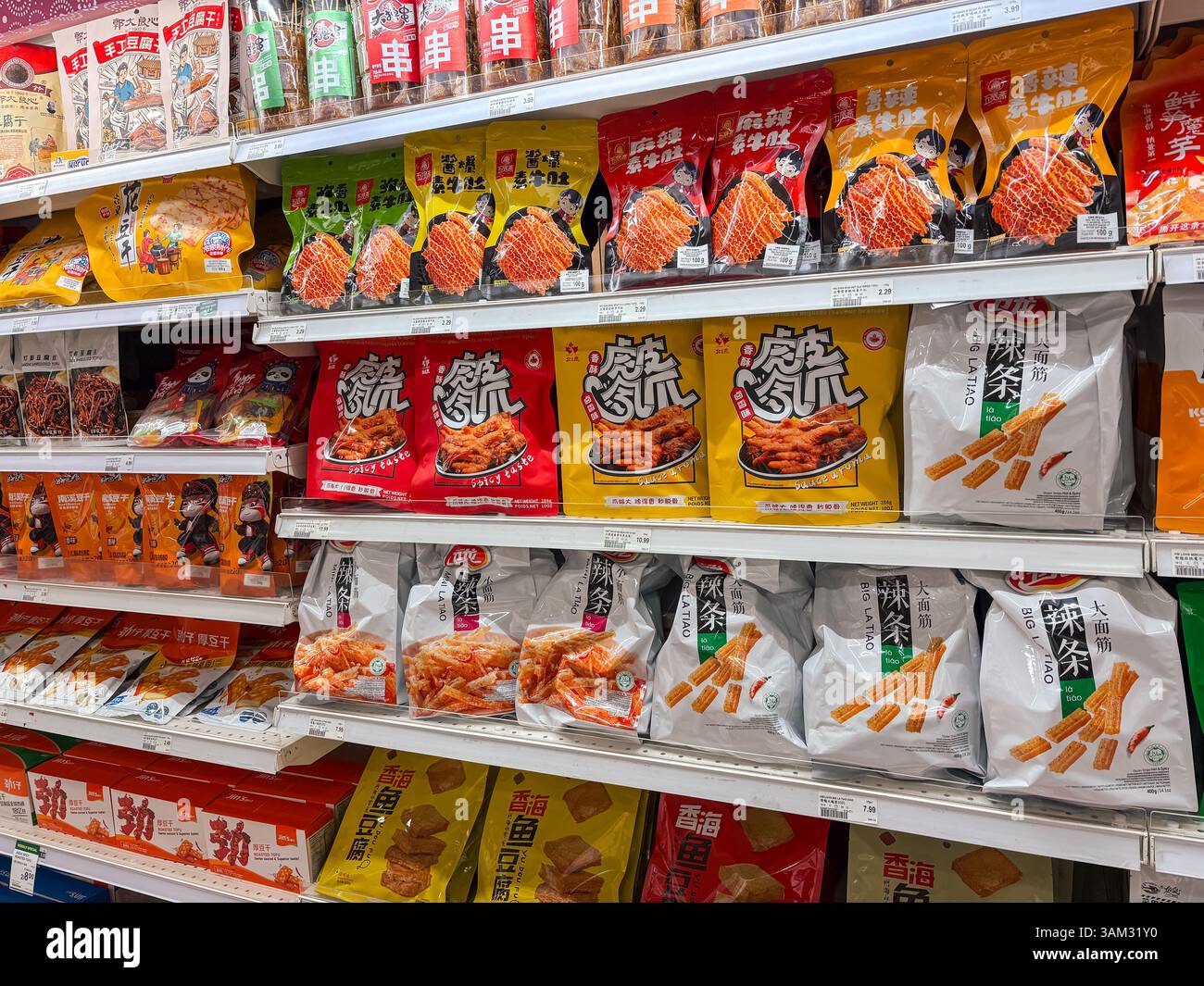 Shelves are stocked with unhealthy and processed snacks in a Chinese ...