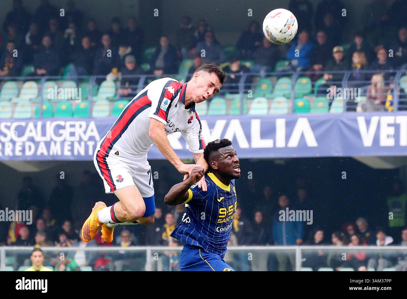 Genoa's Patrizio Masini, top, and Verona's Daniel Mosquera vie for the ...