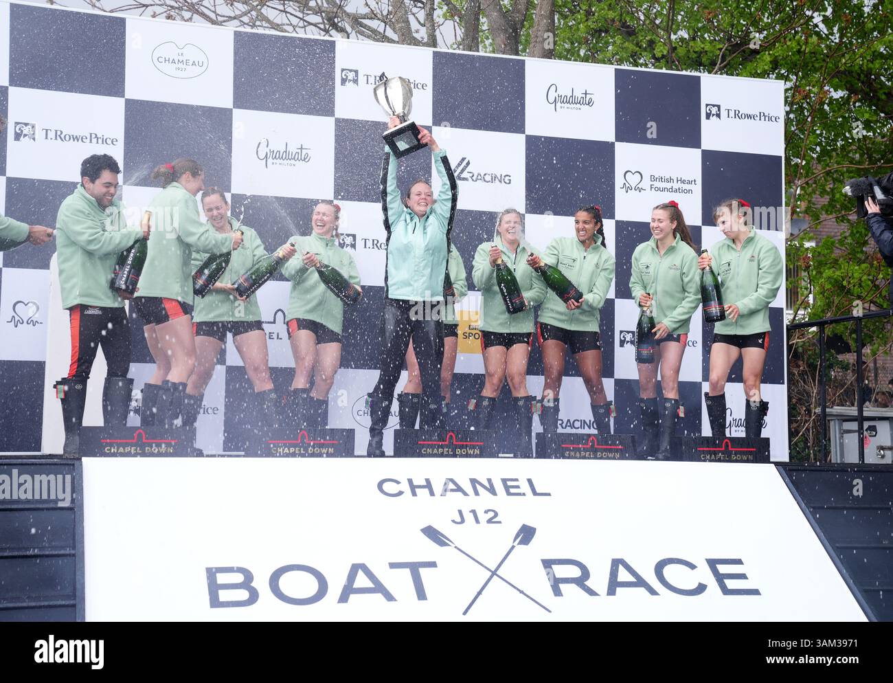 Cambridge Women's President Lucy Havard lifts the trophy as they ...
