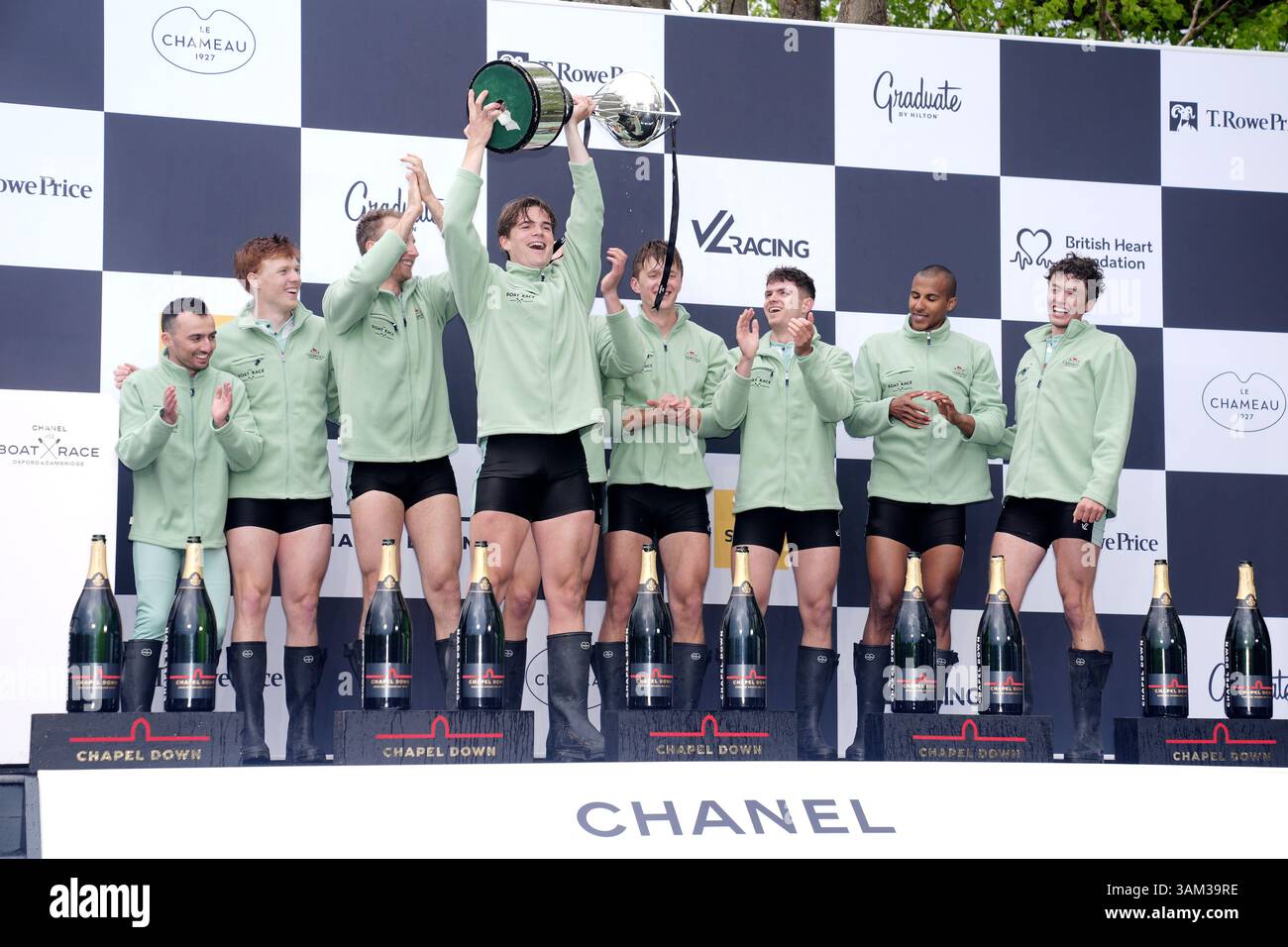 Cambridge Men's President Luca Ferraro lifts the trophy as they ...