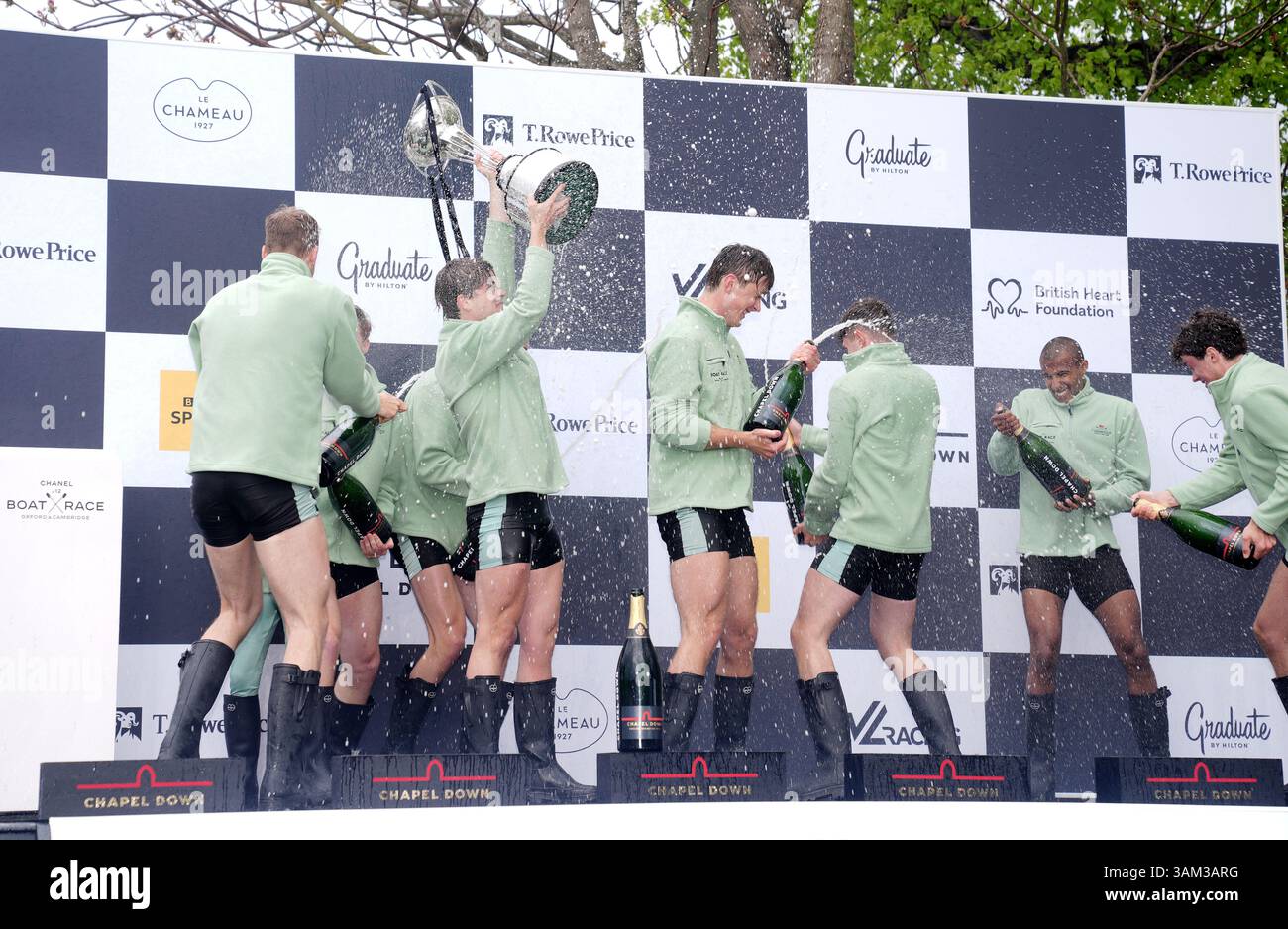 Cambridge Men's President Luca Ferraro lifts the trophy as they ...