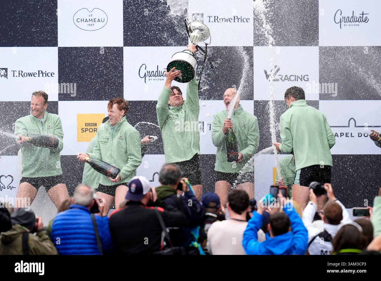 Cambridge men's team president Luca Ferraro celebrates with the trophy ...