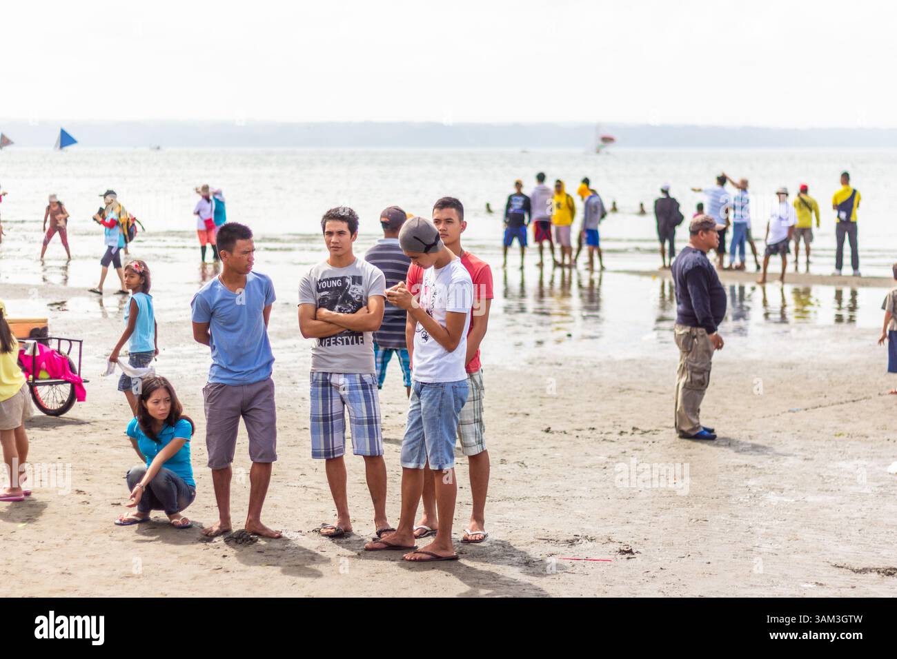 Filipino Ilonggo beachgoers spend a holiday by the shore at a popular ...