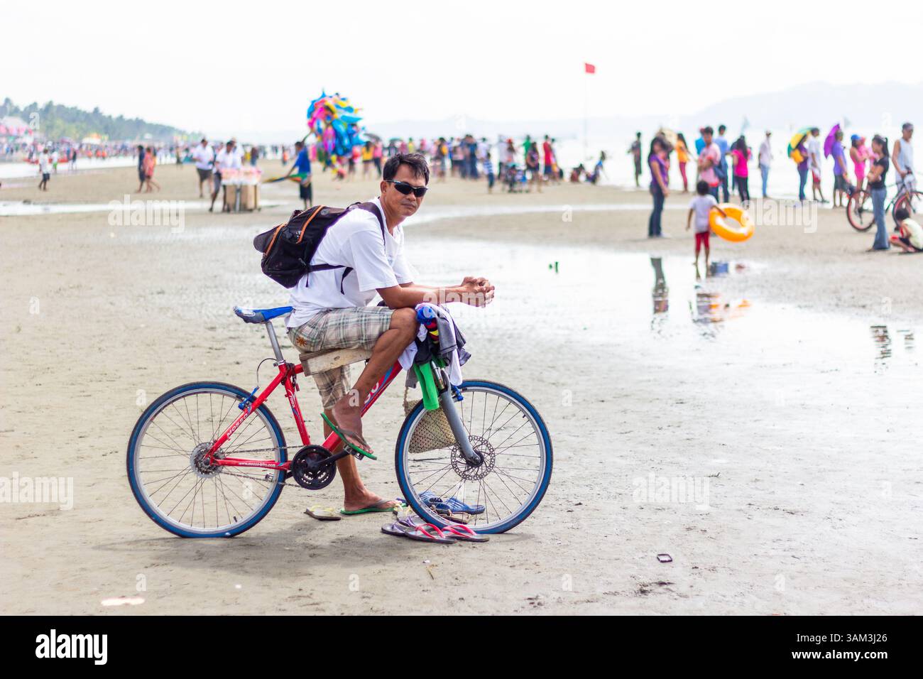 A Filipino Ilonggo male on his bike at a popular public beach during a ...