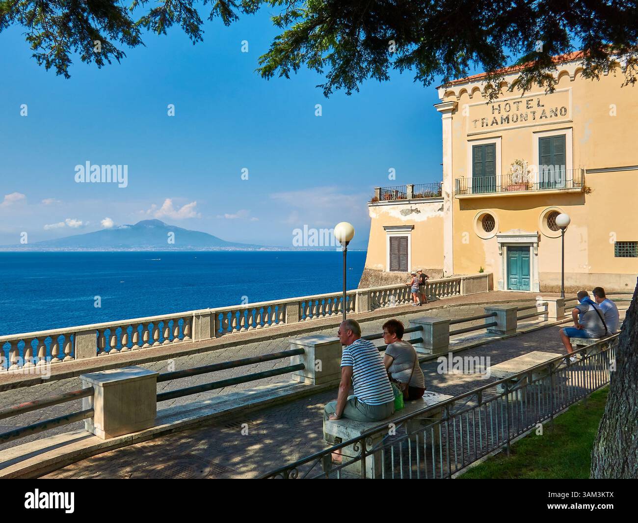 Coastal View of a Mediterranean Hotel by the Sea With People Relaxing ...