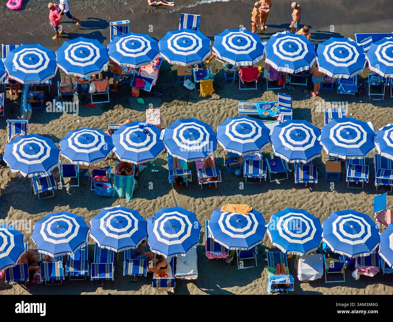 Aerial View of Blue Parasols on a Sandy Beach With Relaxing Sunbathers ...