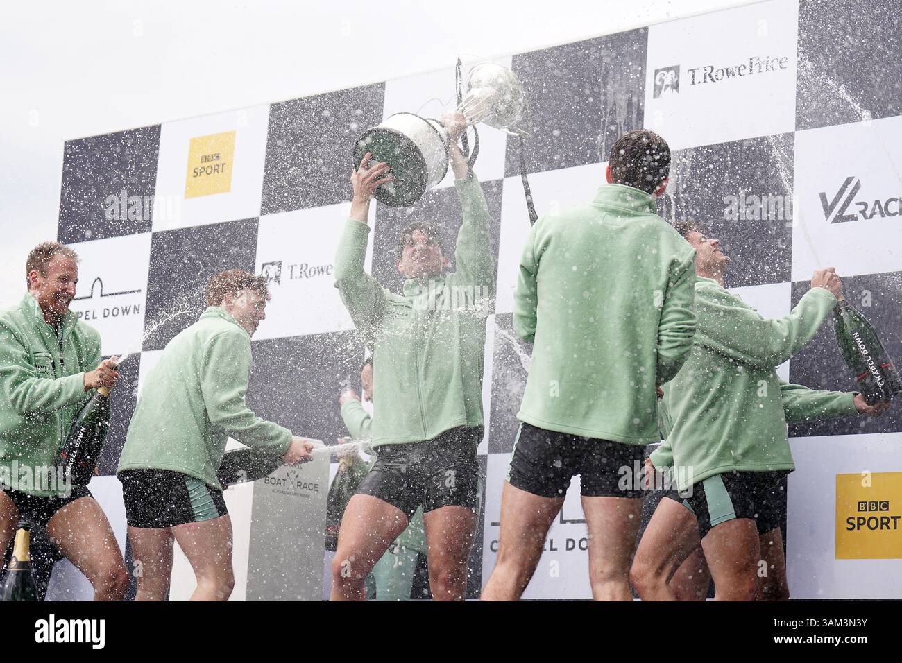 Cambridge Men's President Luca Ferraro lifts the trophy as they ...