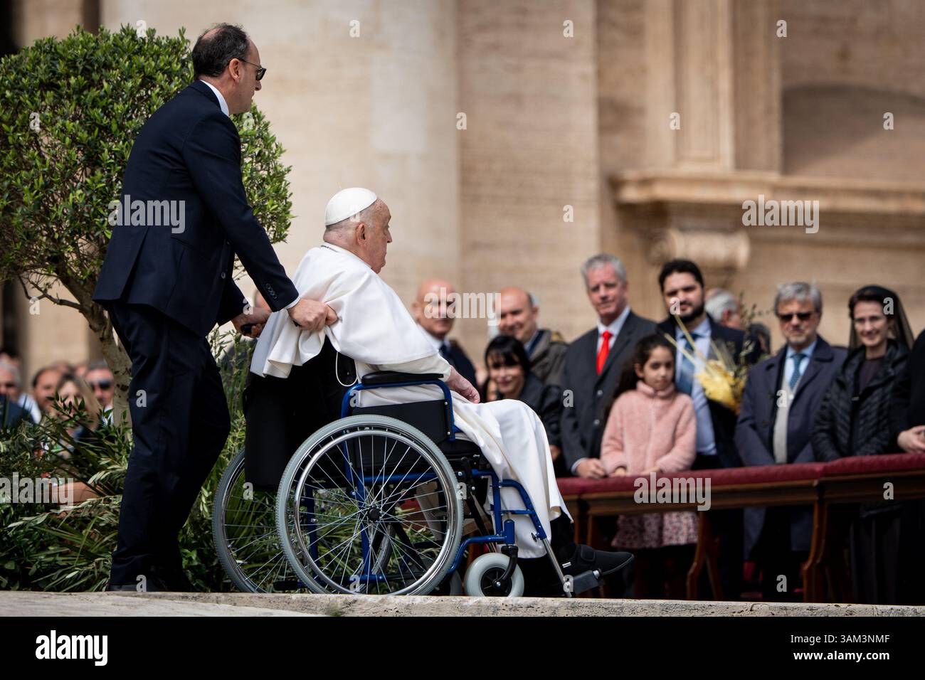 Pope Francis leaves St. Peter's Square in a wheelchair at the end of ...