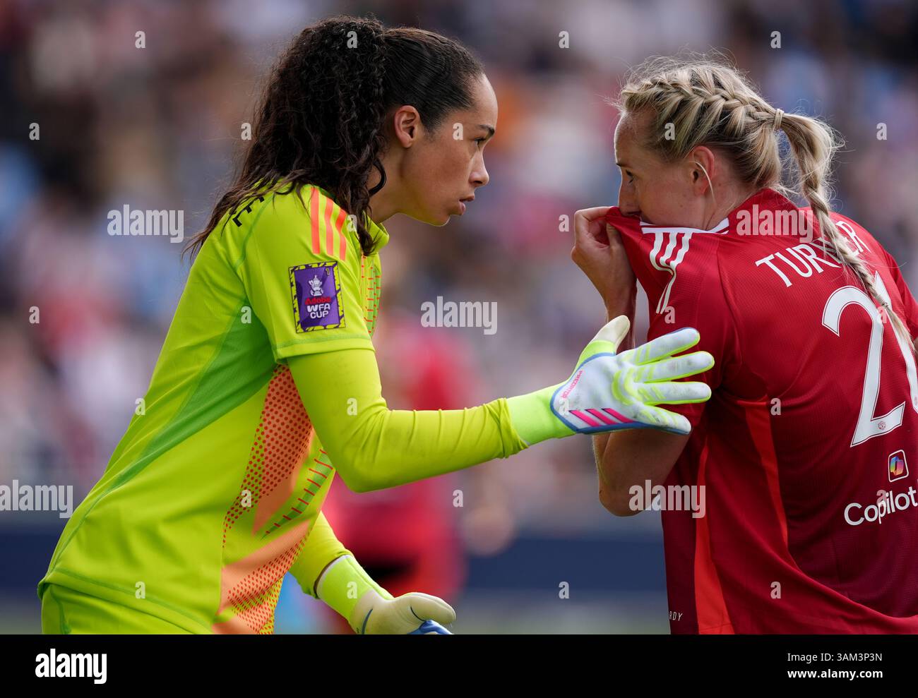 Manchester United goalkeeper Phallon Tullis-Joyce (left) speaks with ...