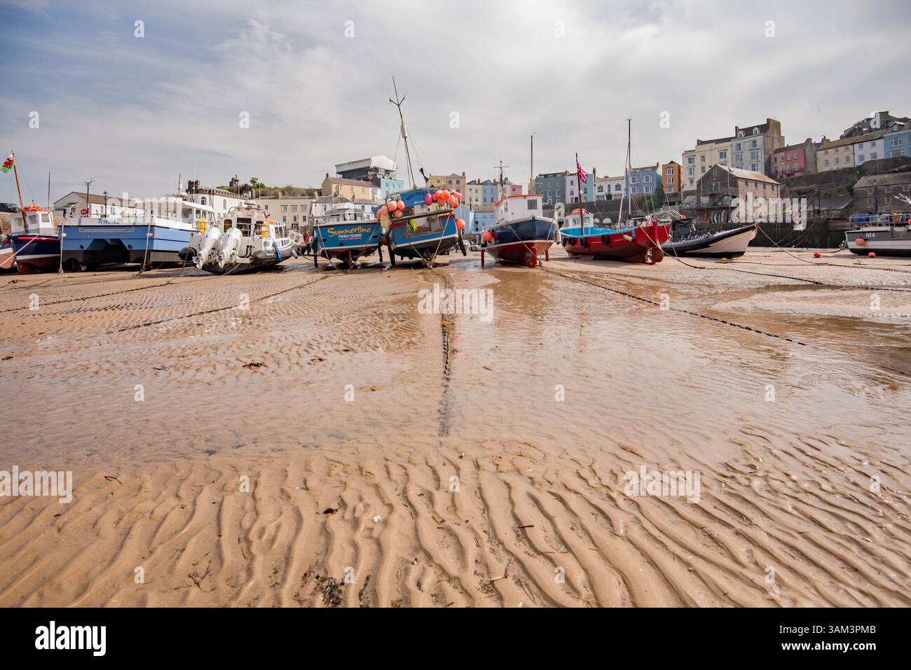 Boats left sitting on the sand as the tide has retreated, Tenby ...