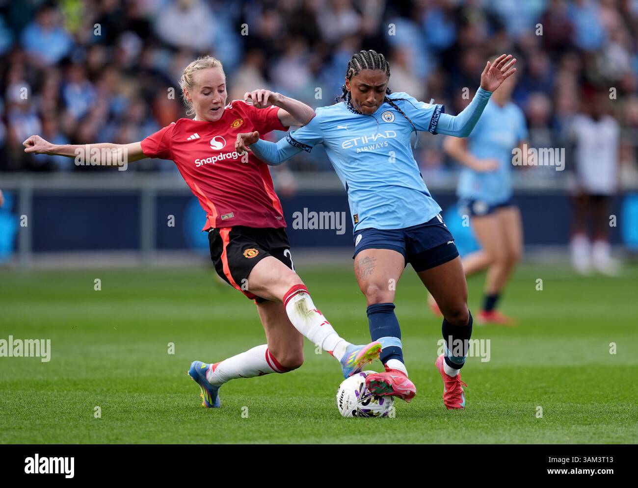 Manchester United's Millie Turner (left) and Manchester City's Kerolin Nicoli battle for the ...