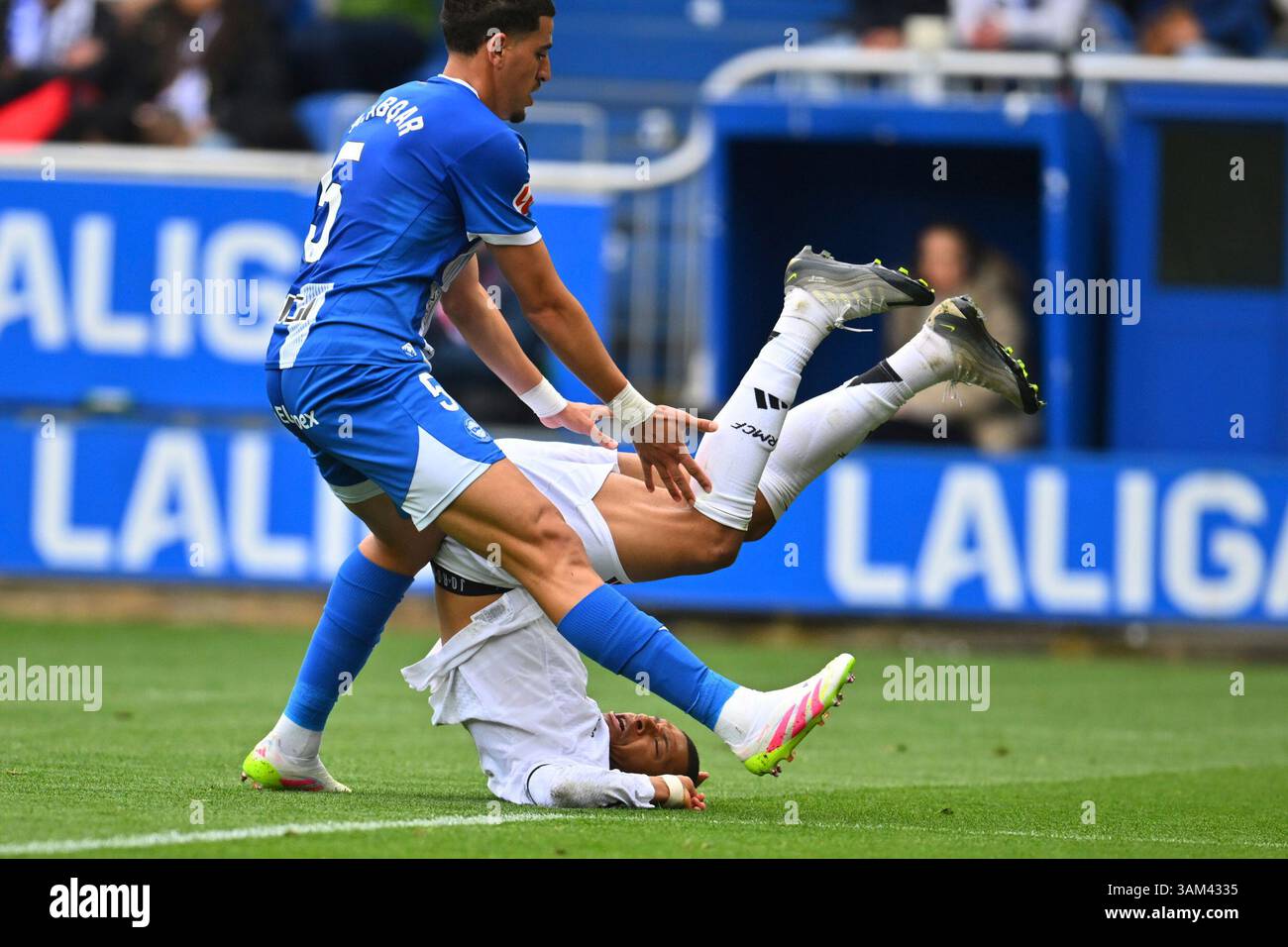 Real Madrid's Kylian Mbappe falls in front of Alaves' Abdel Abqar ...