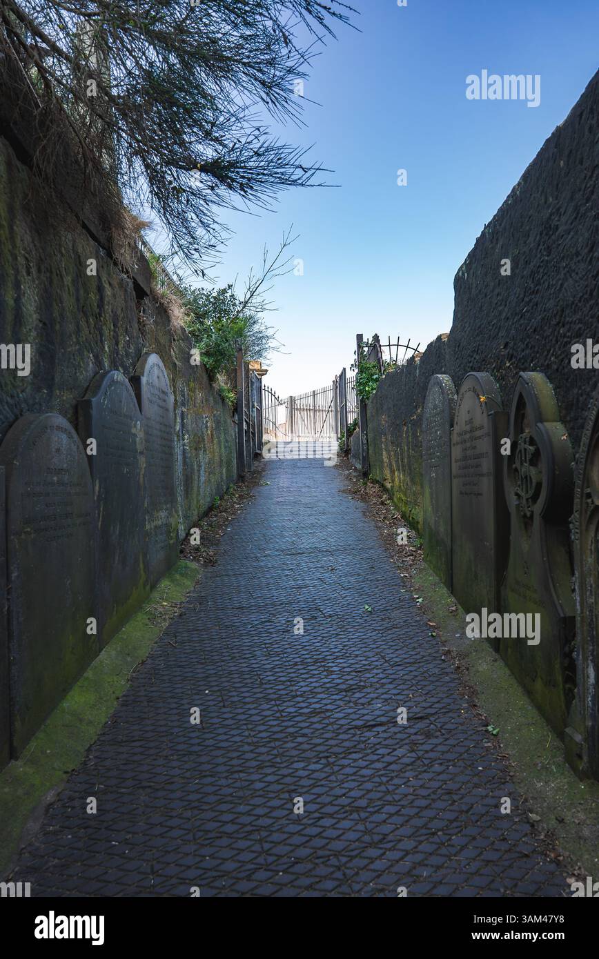 Cobblestone Pathway with Gravestones Leading to Wrought Iron Gate Stock ...