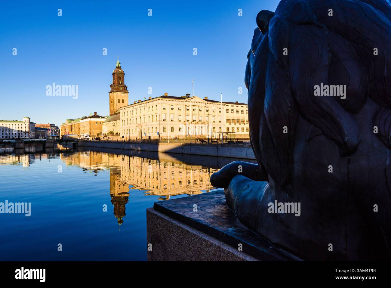 Golden light bathes the canal in Gothenburg as historical architecture ...