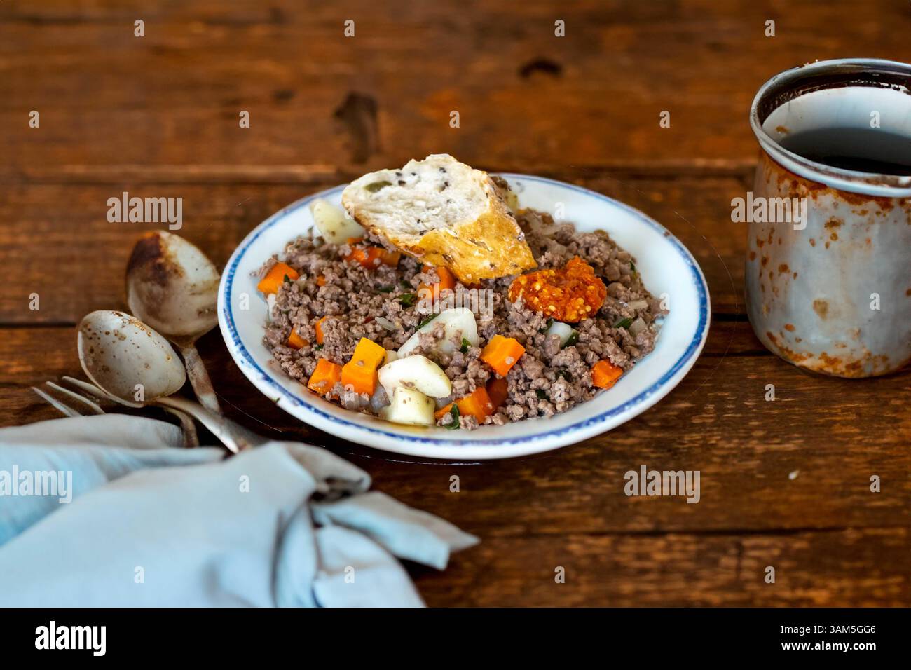 Traditional dish with ground beef and vegetables on an old plate and ...