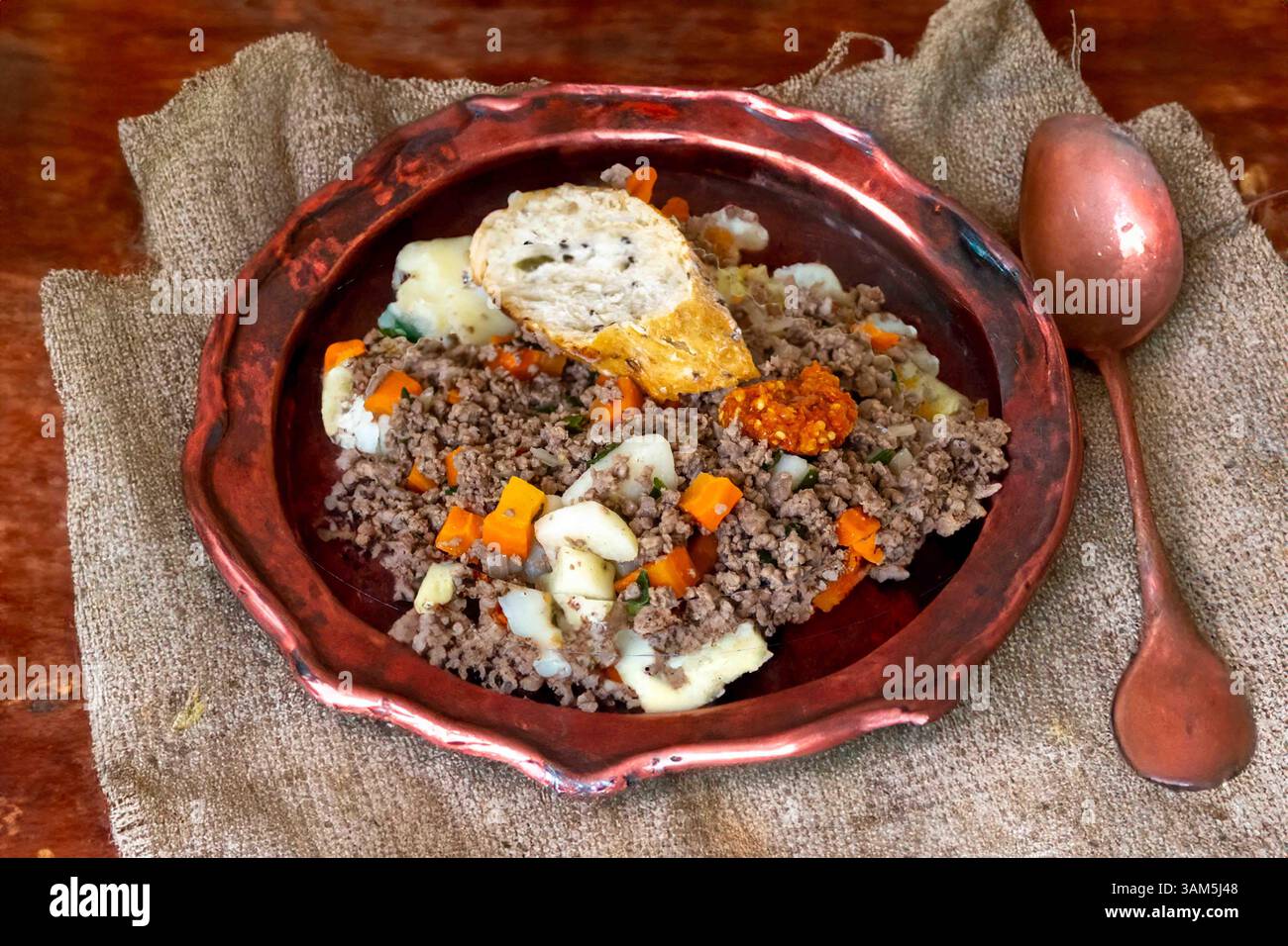Traditional dish with ground beef and vegetables on an old plate and ...