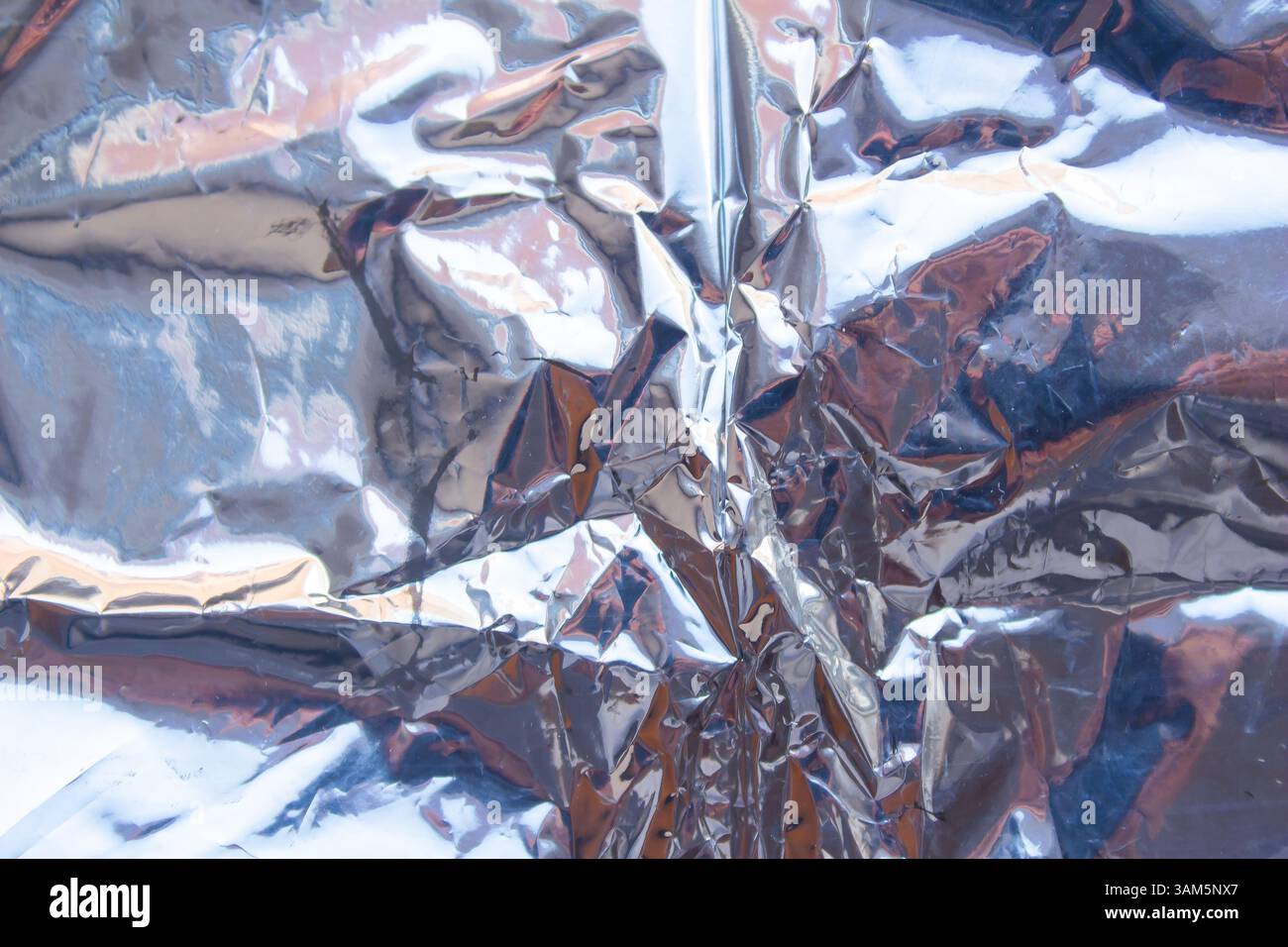 Crumpled reflective shiny gift wrapping material texture background ...