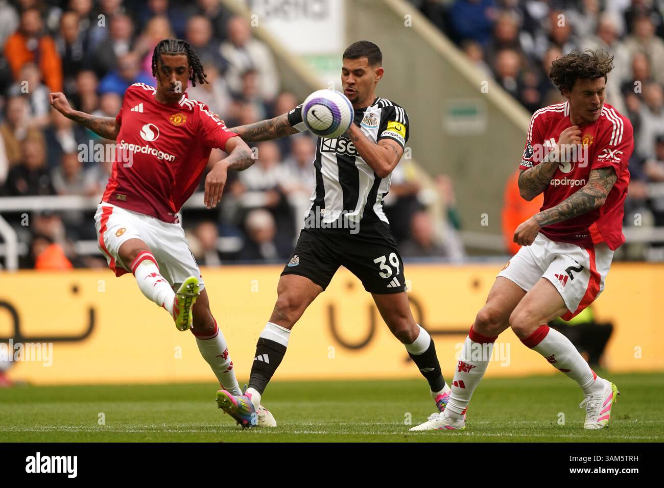 Newcastle United's Bruno Guimaraes (centre) battles with Manchester ...