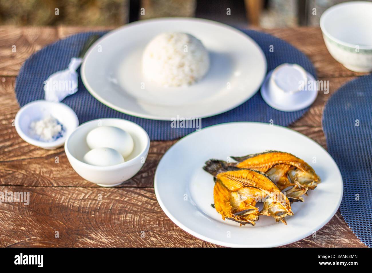 A traditional Filipino breakfast of rice, dried fish, and hard-boiled ...