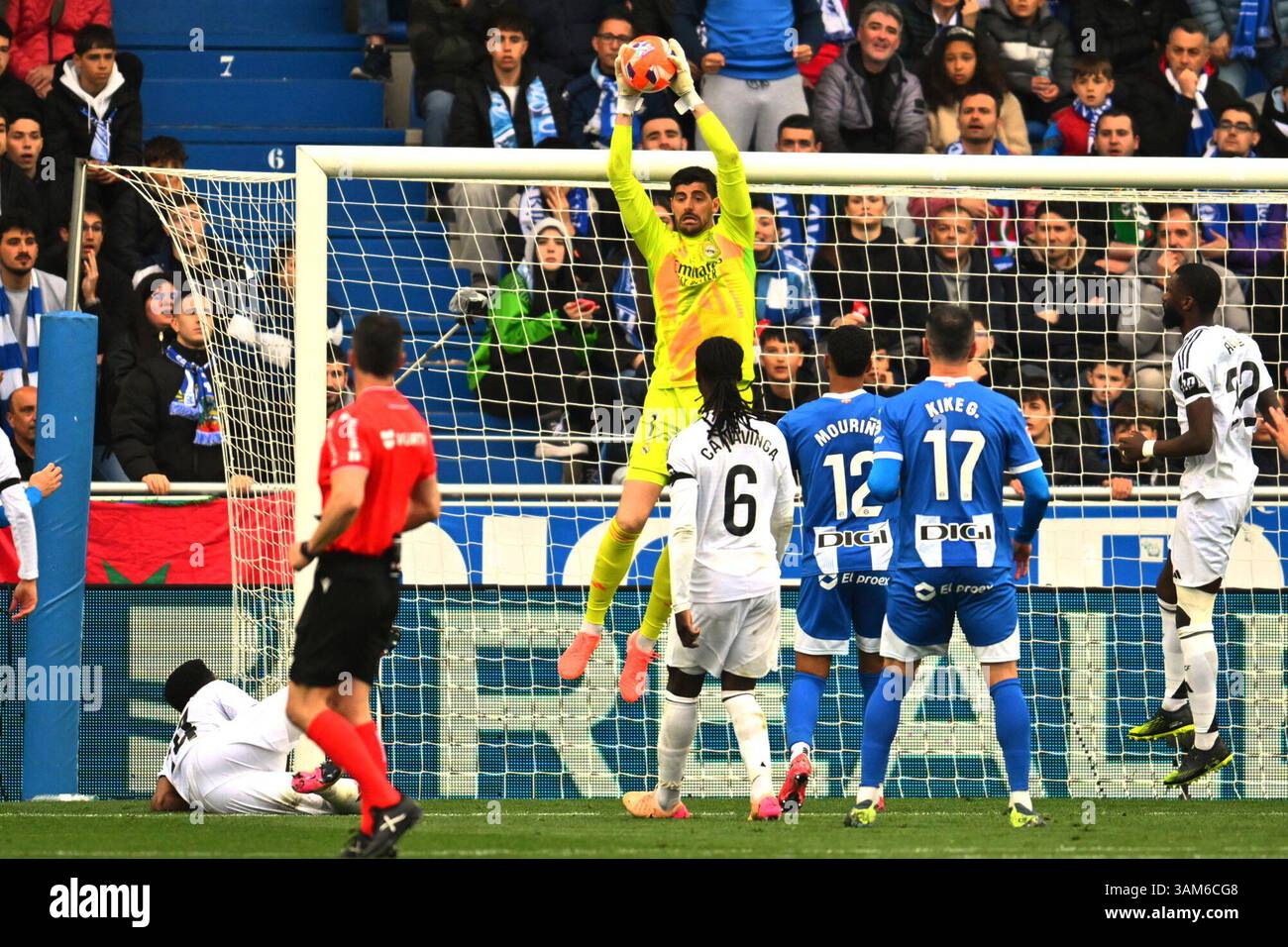 Real Madrid's goalkeeper Thibaut Courtois jumps to catch the ball ...