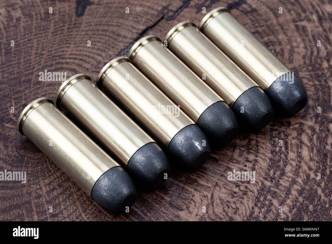 American Long Colt .45 caliber revolver cartridges on a wooden table ...