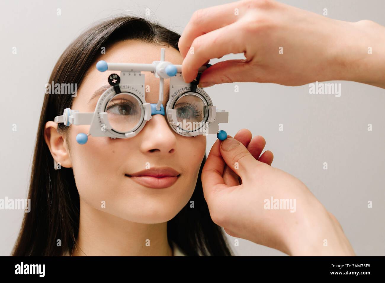Girl is wearing trial frame glasses for eye exam vision test by ...