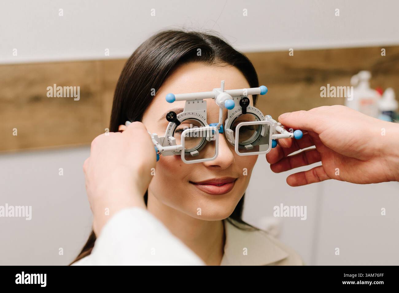 Girl is wearing trial frame glasses for eye exam vision test by ...