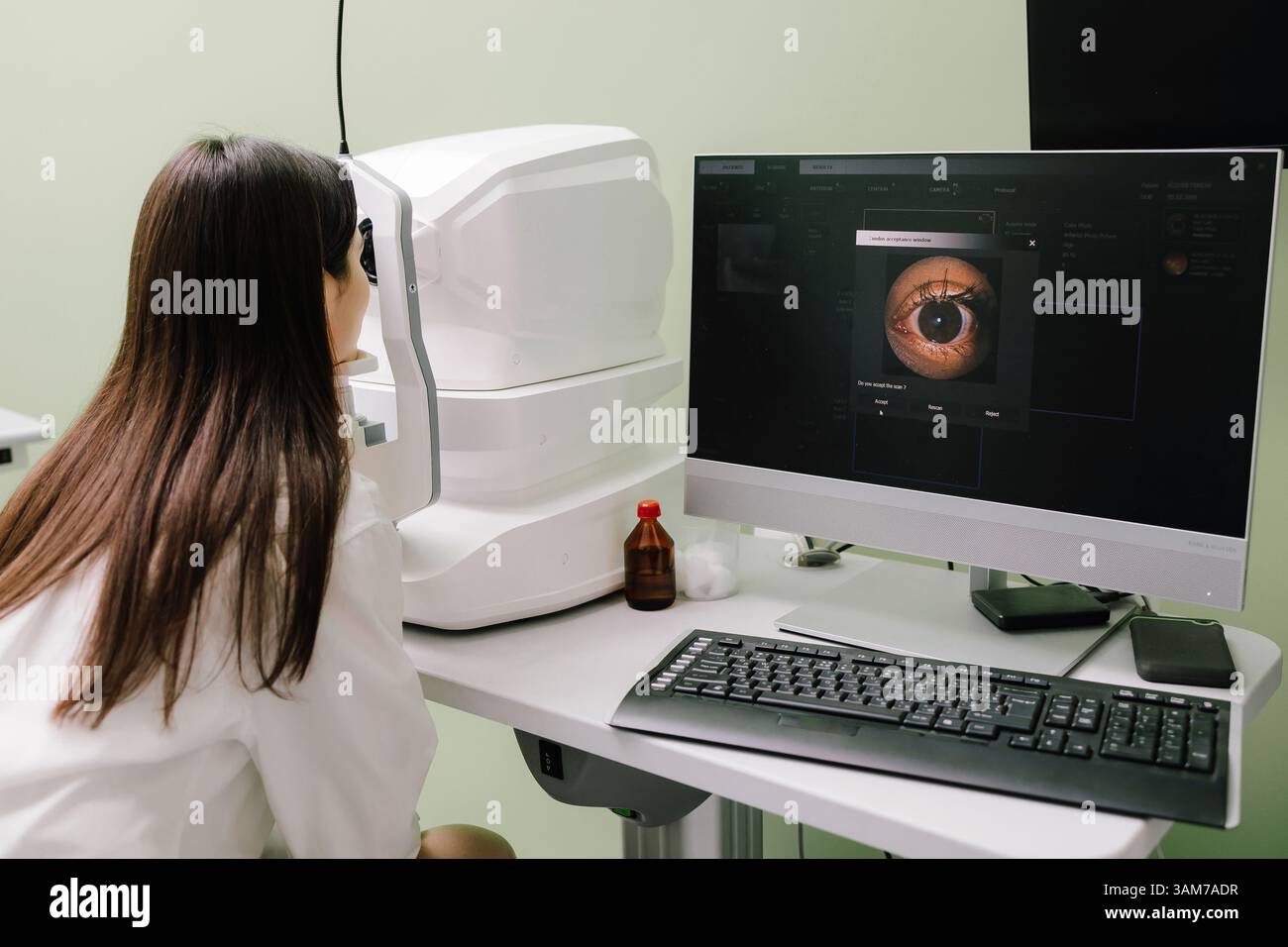 OCT eye scan imaging at an ophthalmology clinic. Girl undergoes a ...