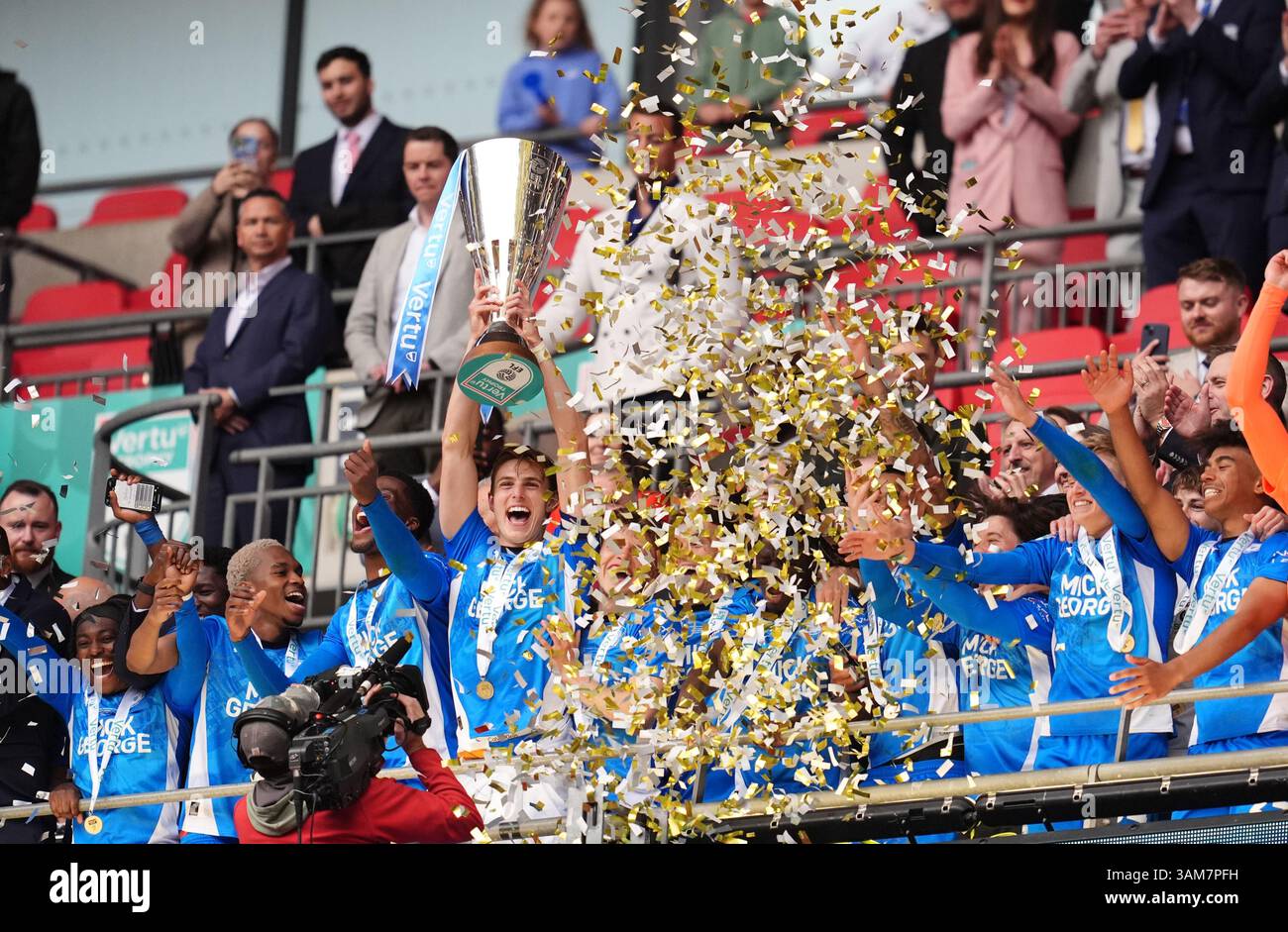 Peterborough United's Hector Kyprianou lifts the trophy after winning ...