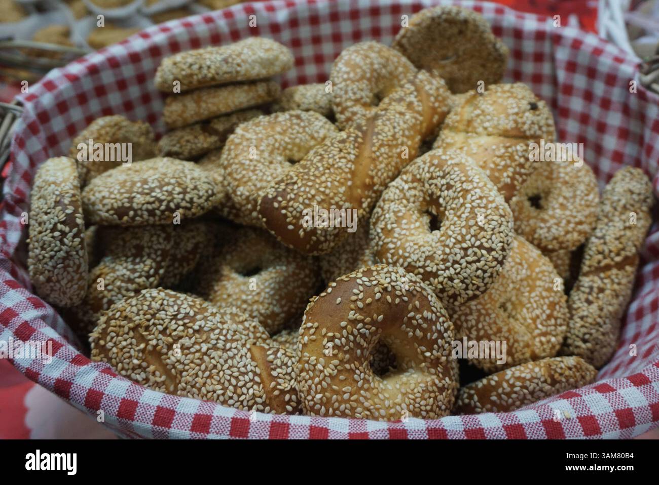 Traditional Cretan sesame cookies in a basket covered with plaid fabric ...