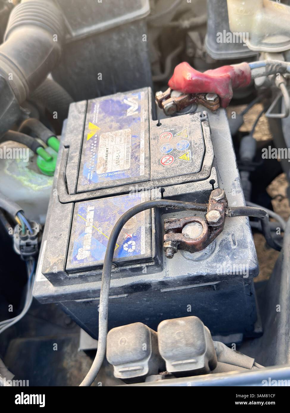 An old car battery still connected Stock Photo - Alamy