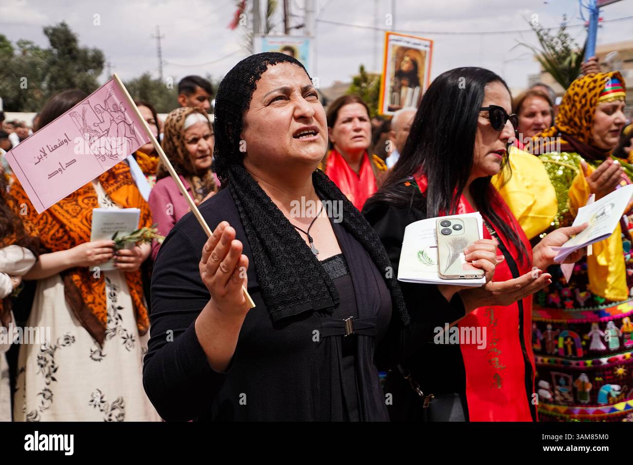 Al Hamdaniya, Iraq. 13th Apr, 2025. An Iraqi Christian woman prays ...