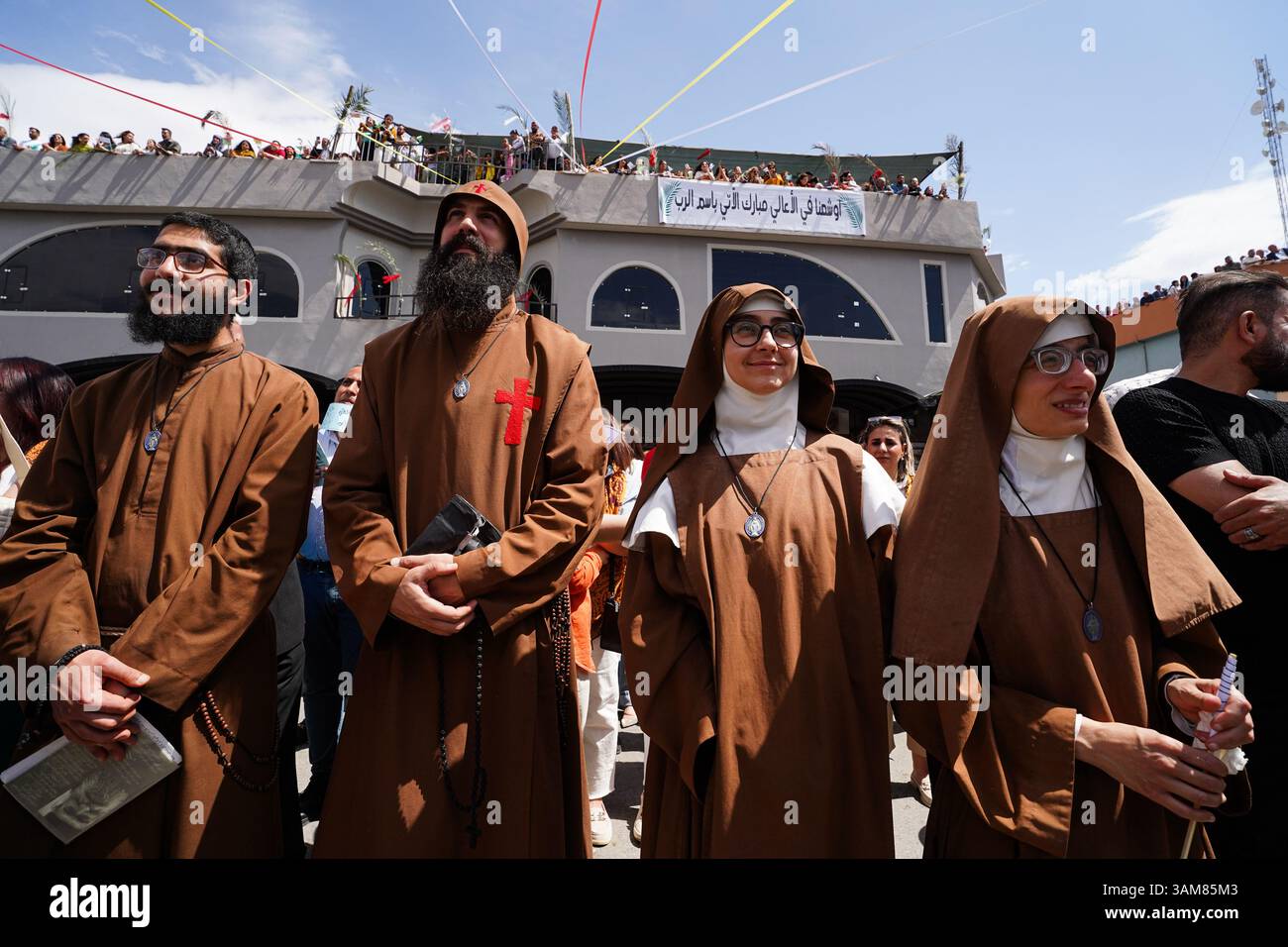 Lebanese monks participate in the Palm Sunday procession in Qaraqosh ...