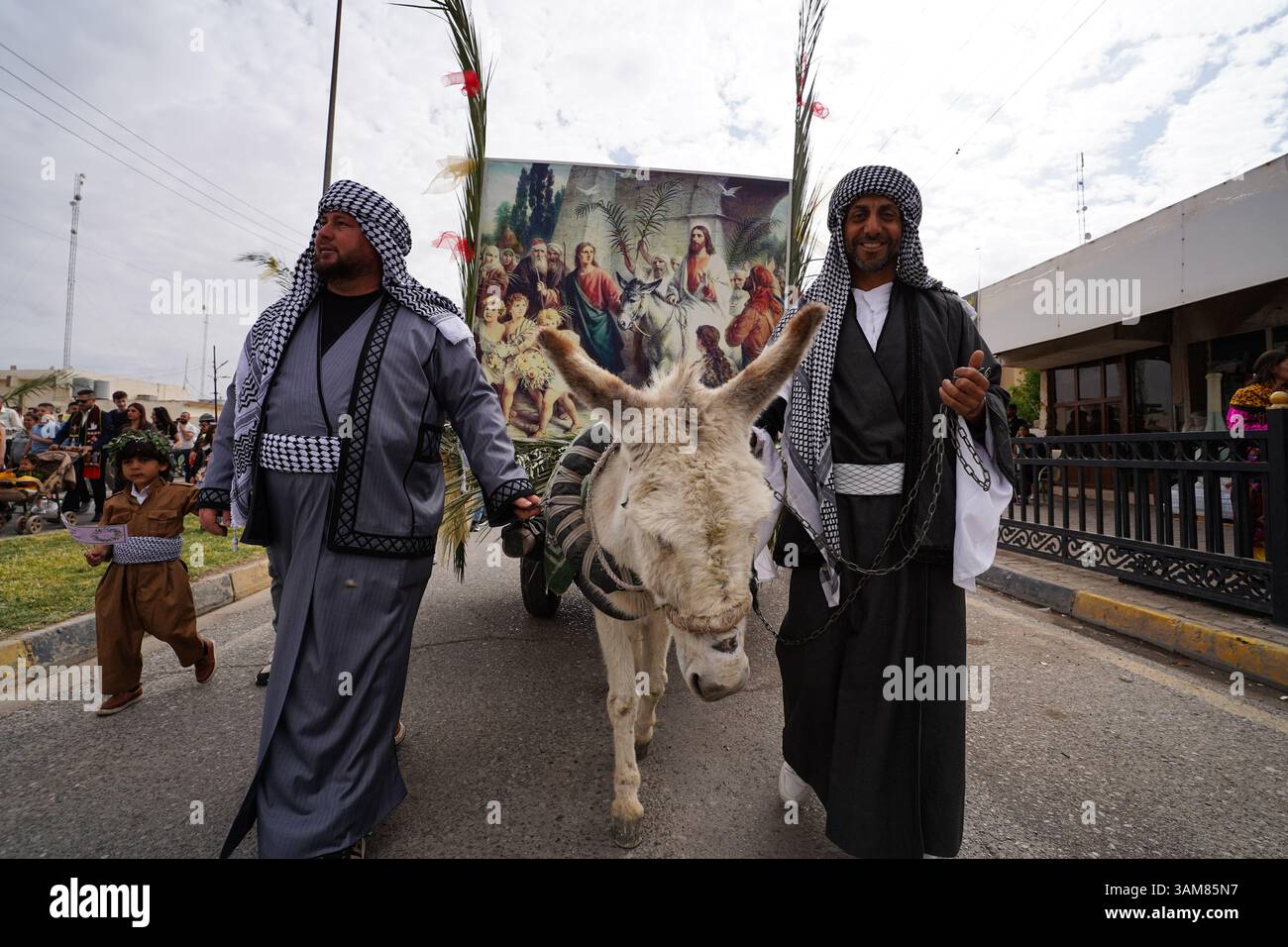 Al Hamdaniya, Iraq. 13th Apr, 2025. Iraqi Christians walk with a donkey ...