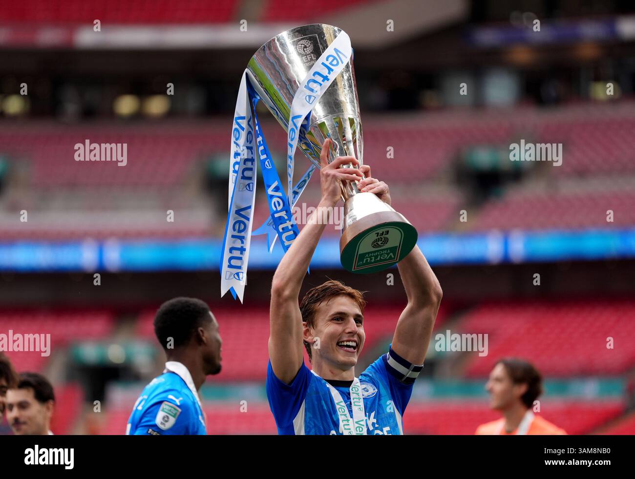 Peterborough United's Hector Kyprianou with the trophy after winning ...