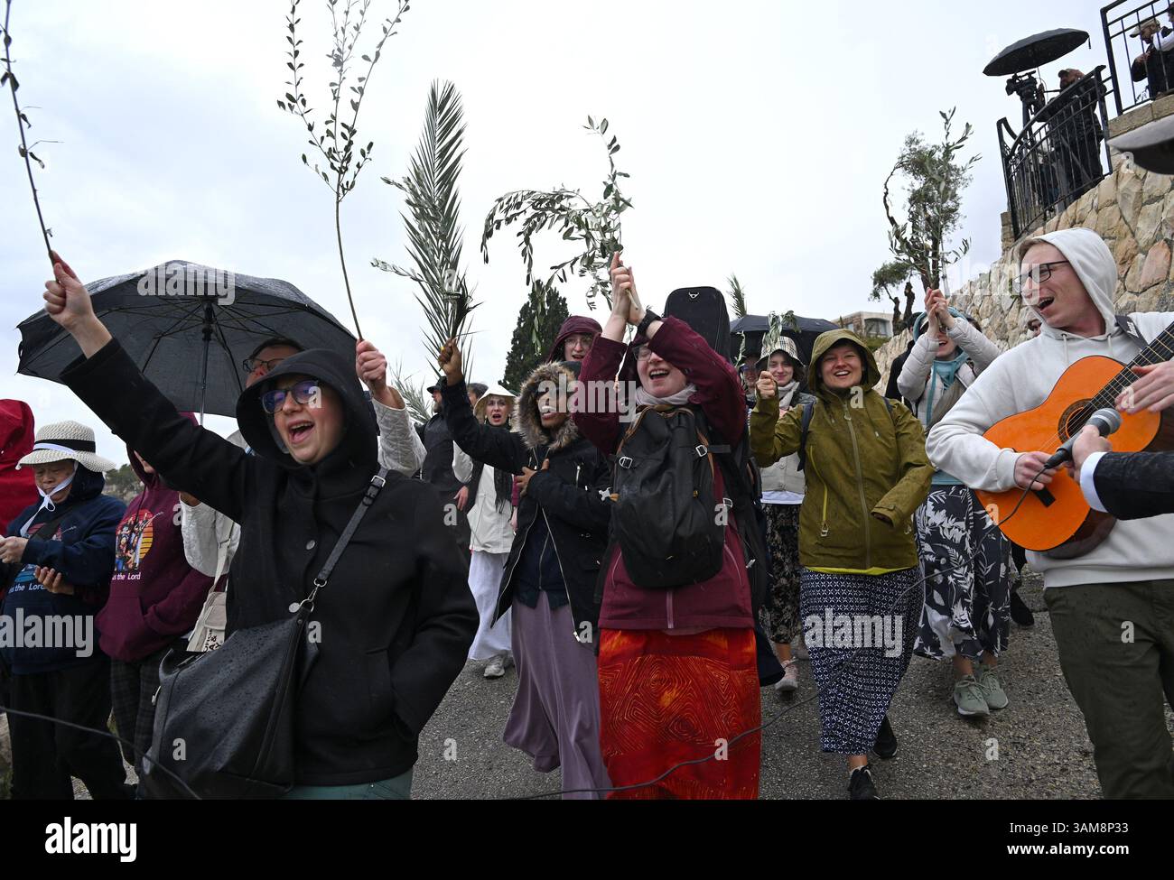 Thousands of Christians wave olive and palm branches during the ...
