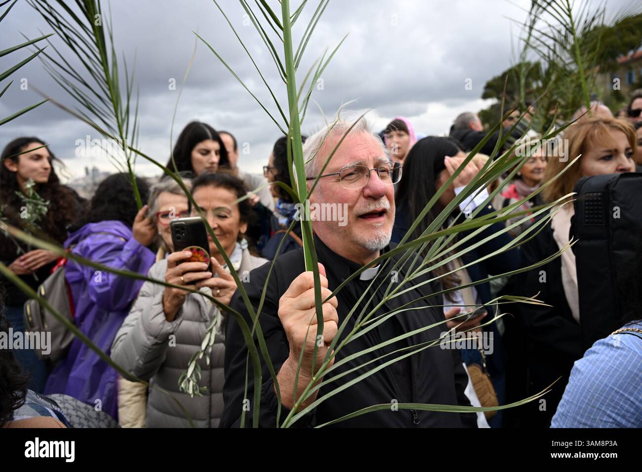 Thousands of Christians wave olive and palm branches during the ...