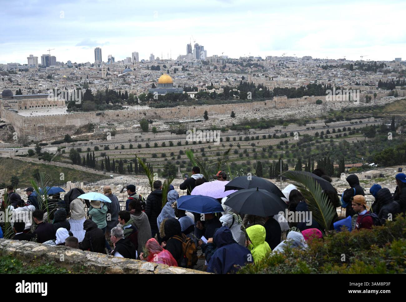 Jerusalem, Israel. 13th Apr, 2025. Christians carry umbrellas during ...