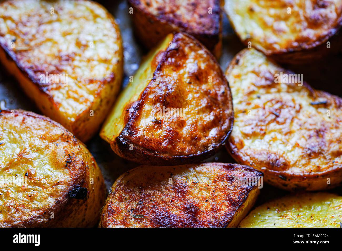 Baked potato pieces close-up. Background with rustic potato texture ...