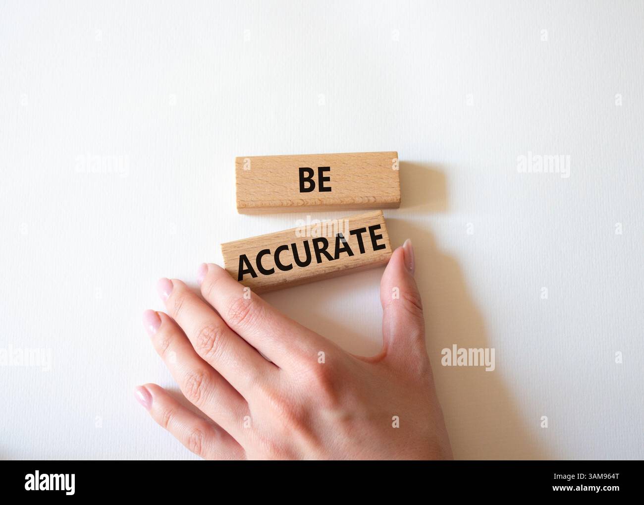 Be accurate symbol. Wooden blocks with words Be accurate. Businessman ...