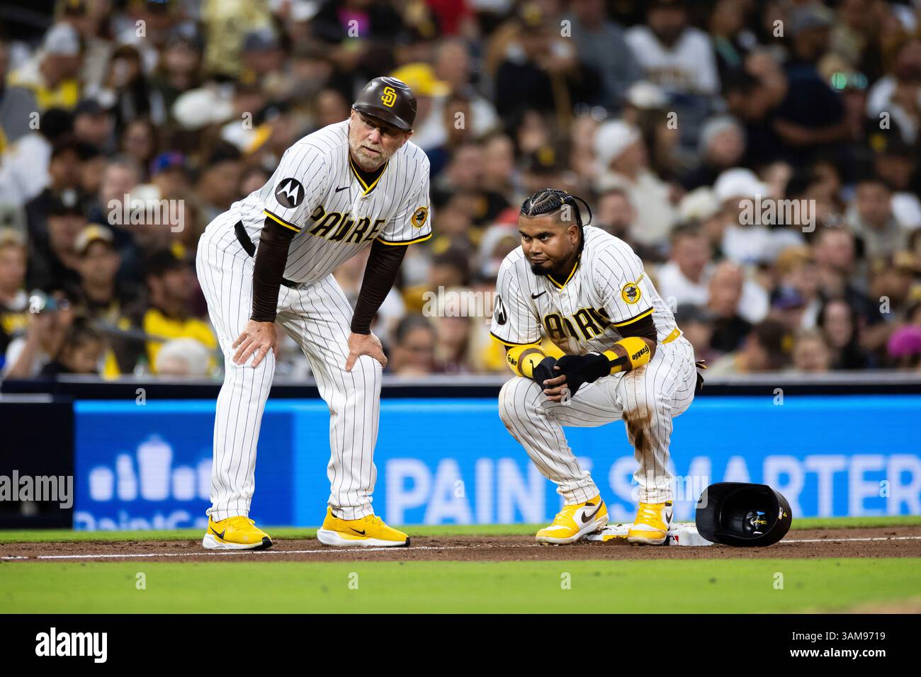 San Diego Padres third base coach Tim Leiper talks with Luis Arraez ...