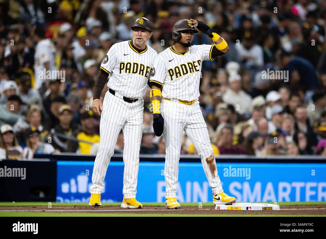 San Diego Padres third base coach Tim Leiper talks with Luis Arraez ...