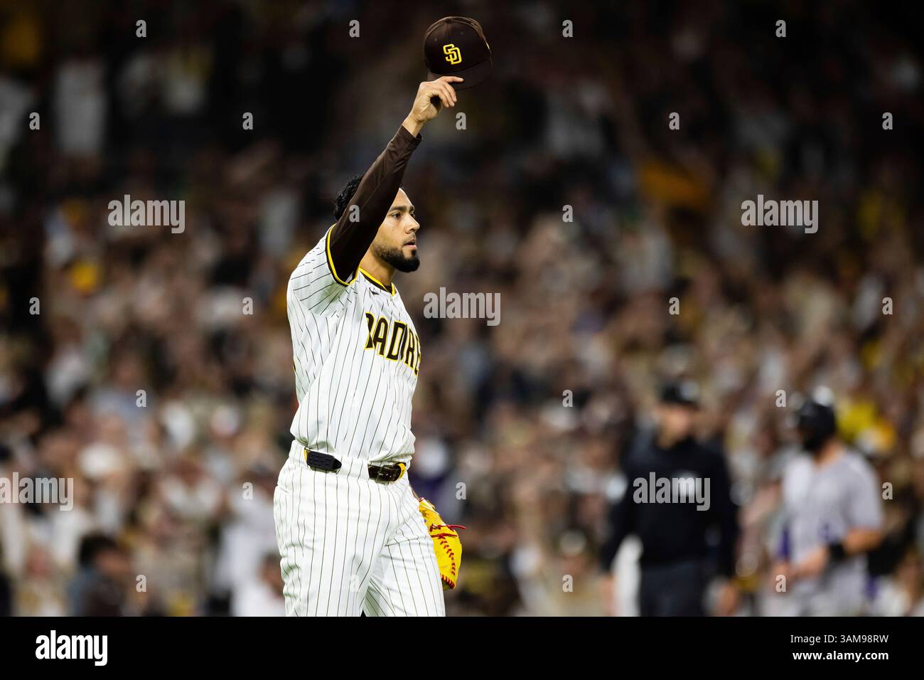 San Diego Padres relief pitcher Robert Suarez tips his cap towards Fernando Tatis Jr. after the ...